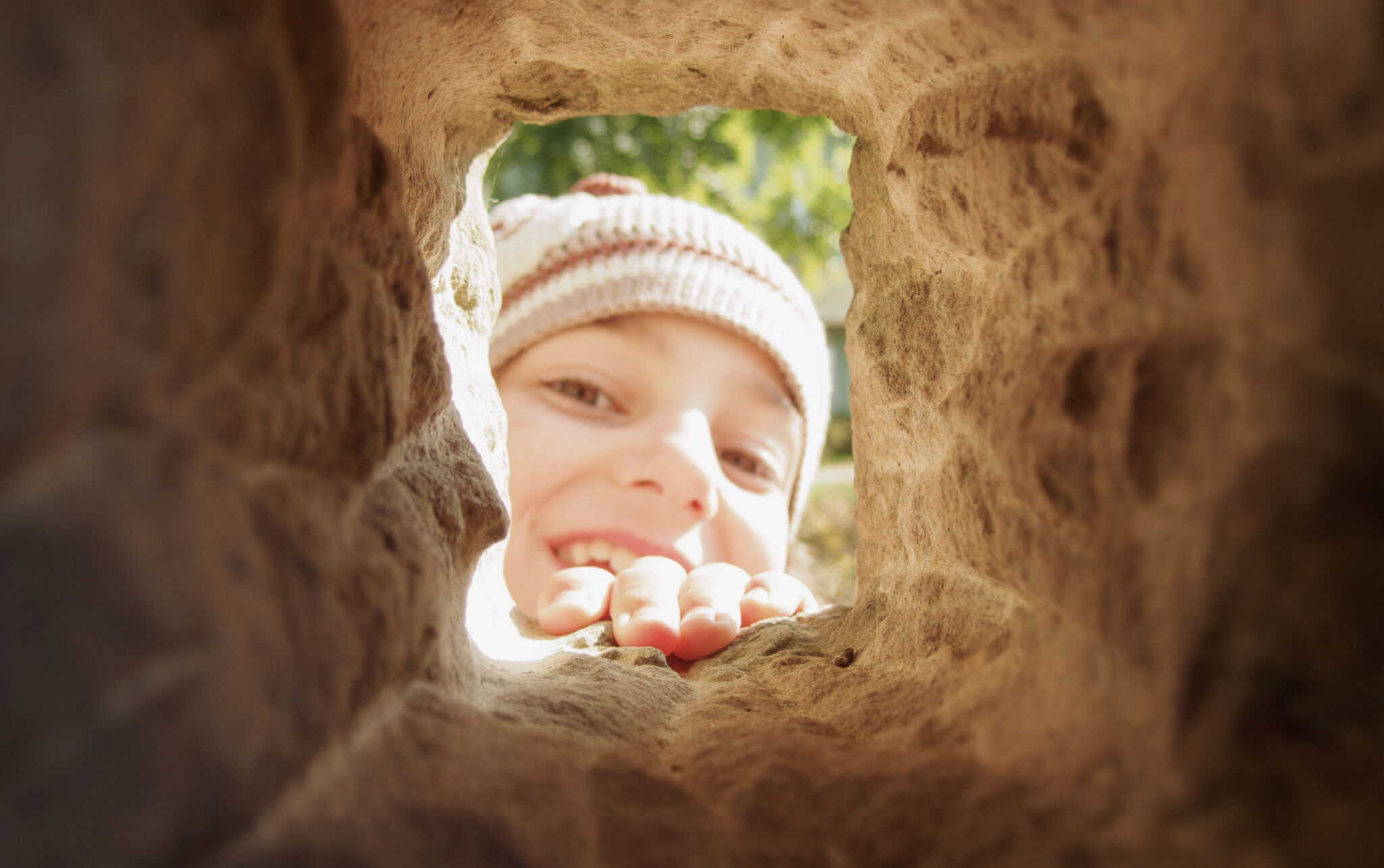 Little smiling girl playing hide and seek | Copyright-free photo (by M ...