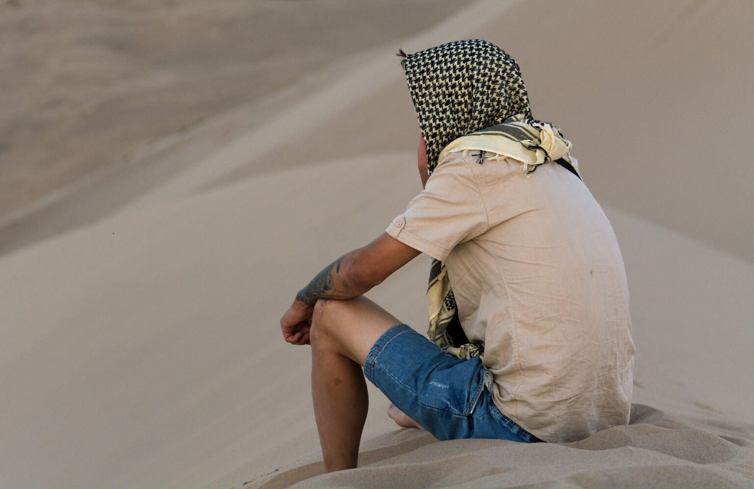 A lonely man sitting on a sand dune | Copyright-free photo (by M. Vorel ...